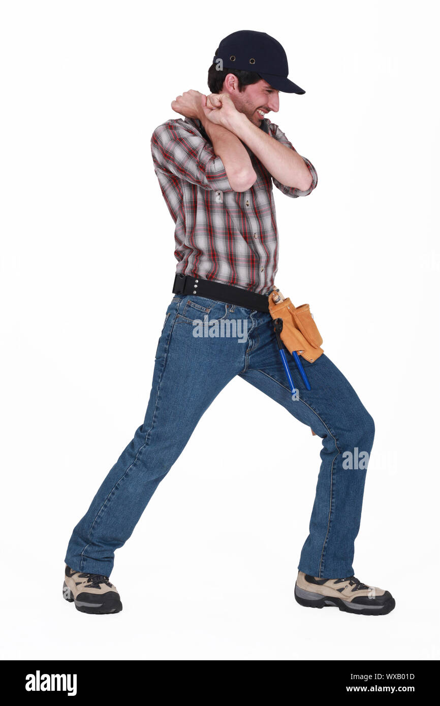 Handyman pulling an invisible object Stock Photo - Alamy
