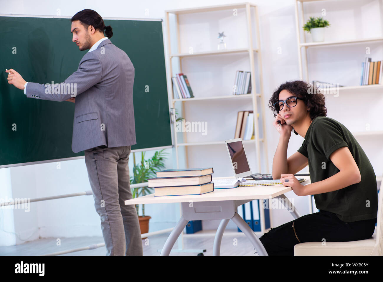 Young teacher and student in the classroom Stock Photo - Alamy