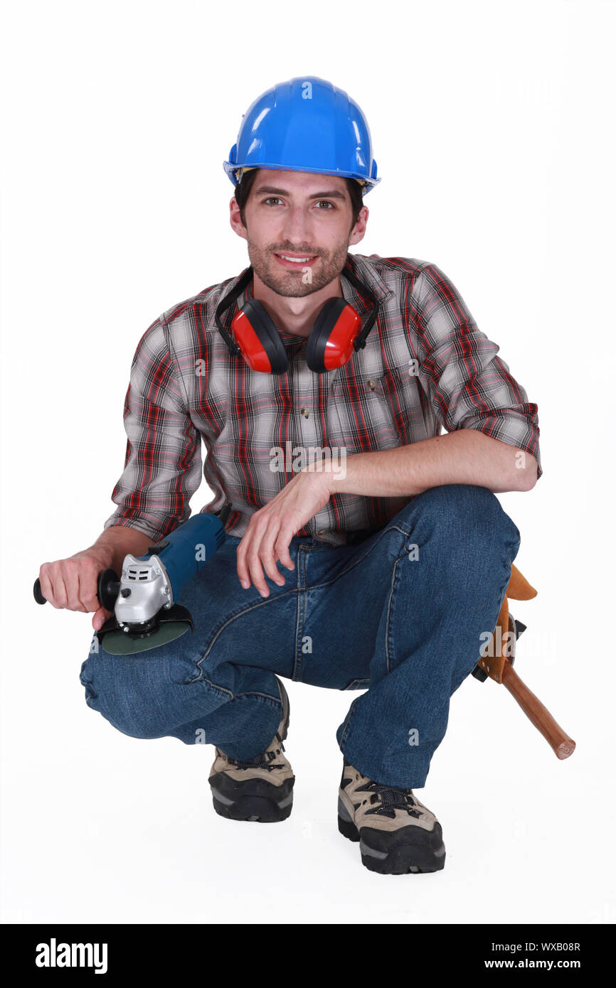A kneeled handyman Stock Photo - Alamy