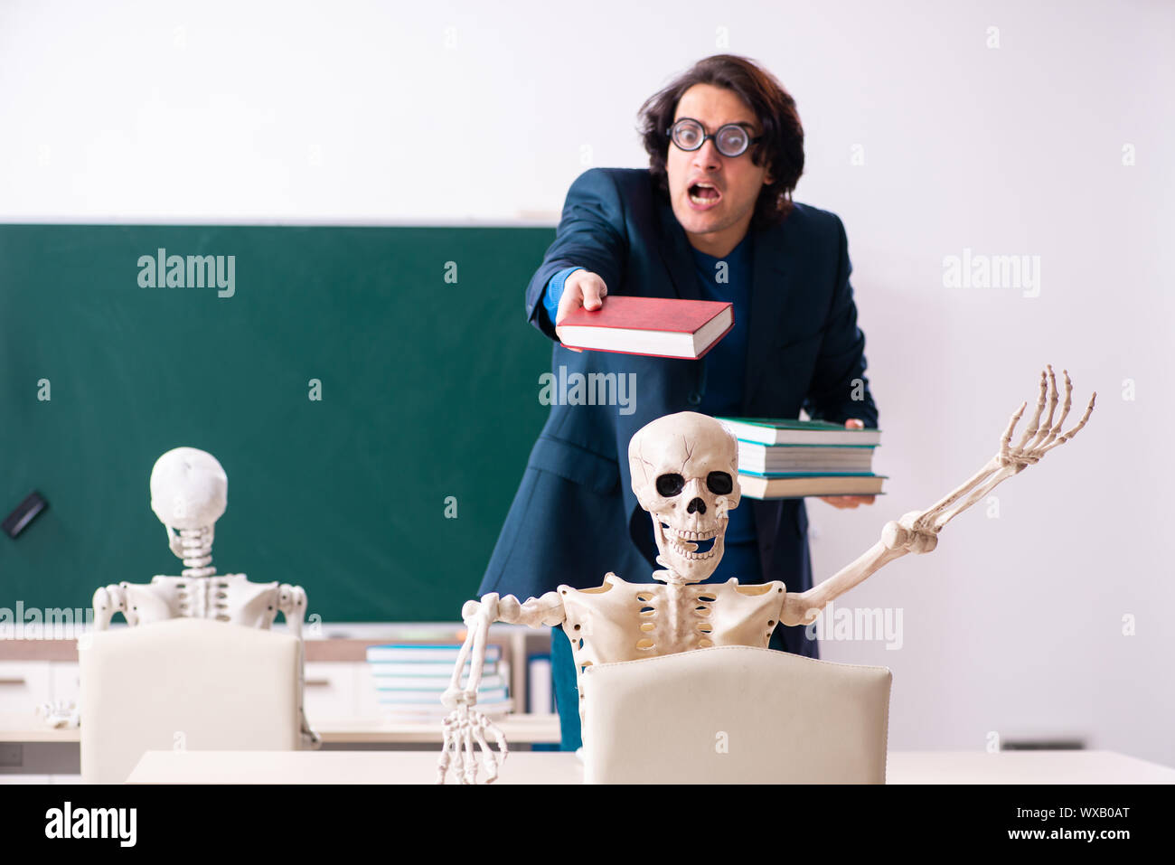 Male teacher and skeleton student in the classroom Stock Photo - Alamy