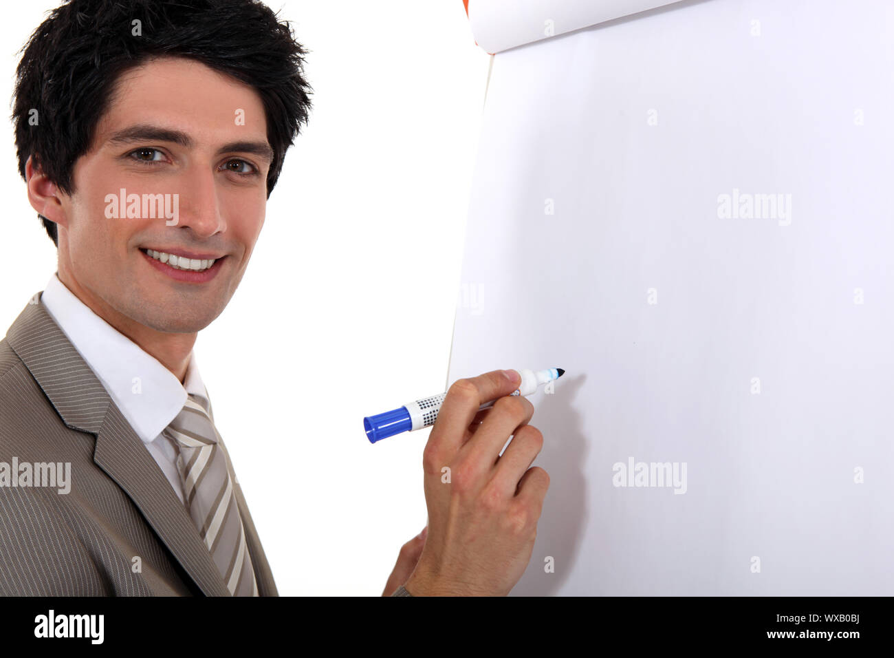 Man writing on flip chart Stock Photo - Alamy