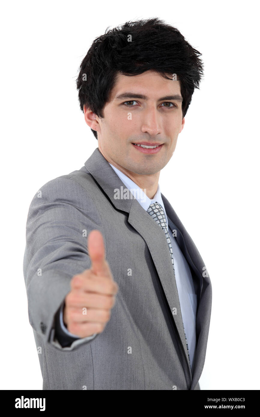 Businessman giving thumbs up Stock Photo - Alamy