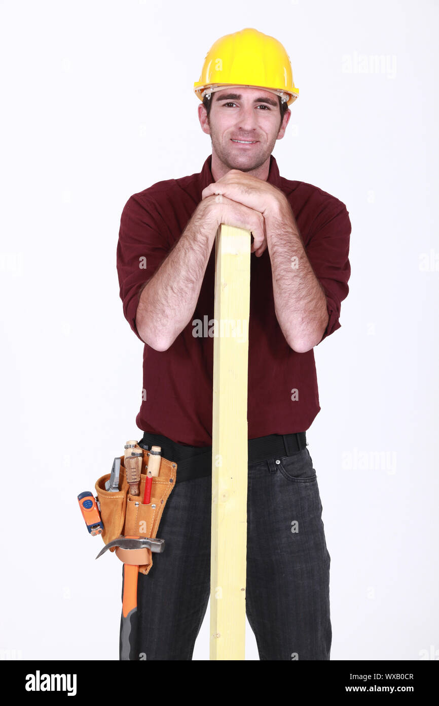 Carpenter stood with of wood Stock Photo - Alamy
