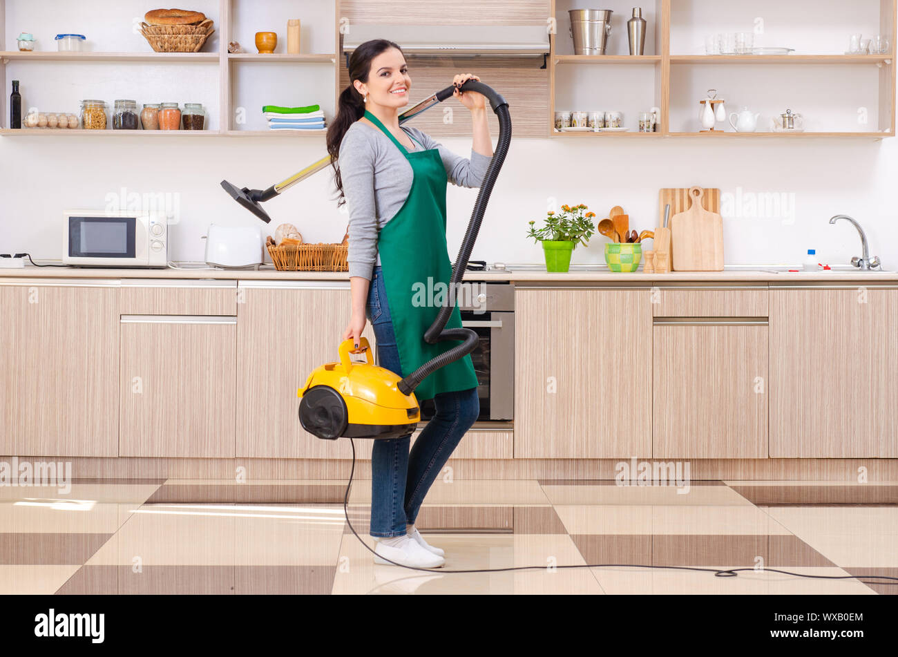 Young female contractor doing housework Stock Photo - Alamy