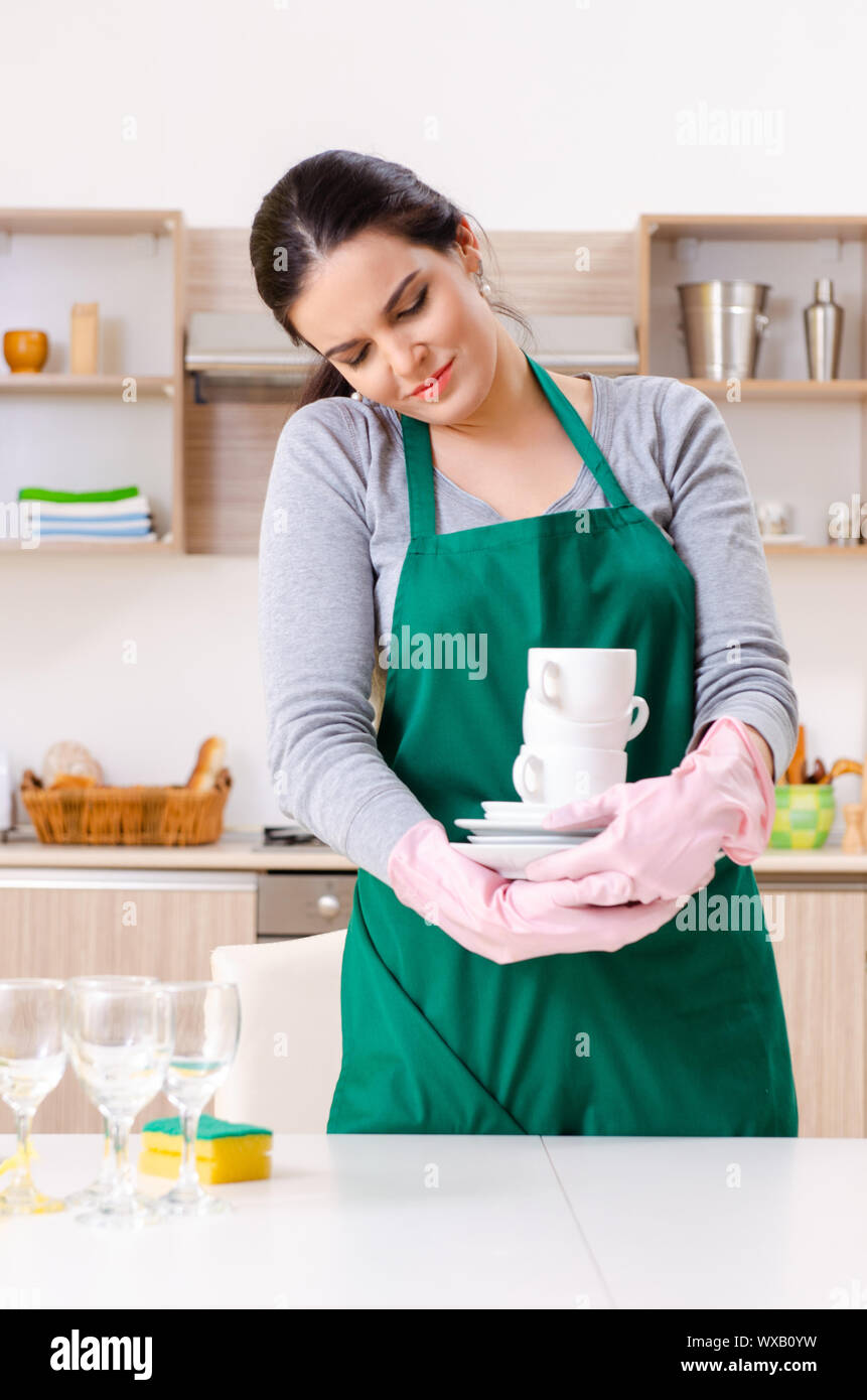 Young female contractor doing housework Stock Photo - Alamy