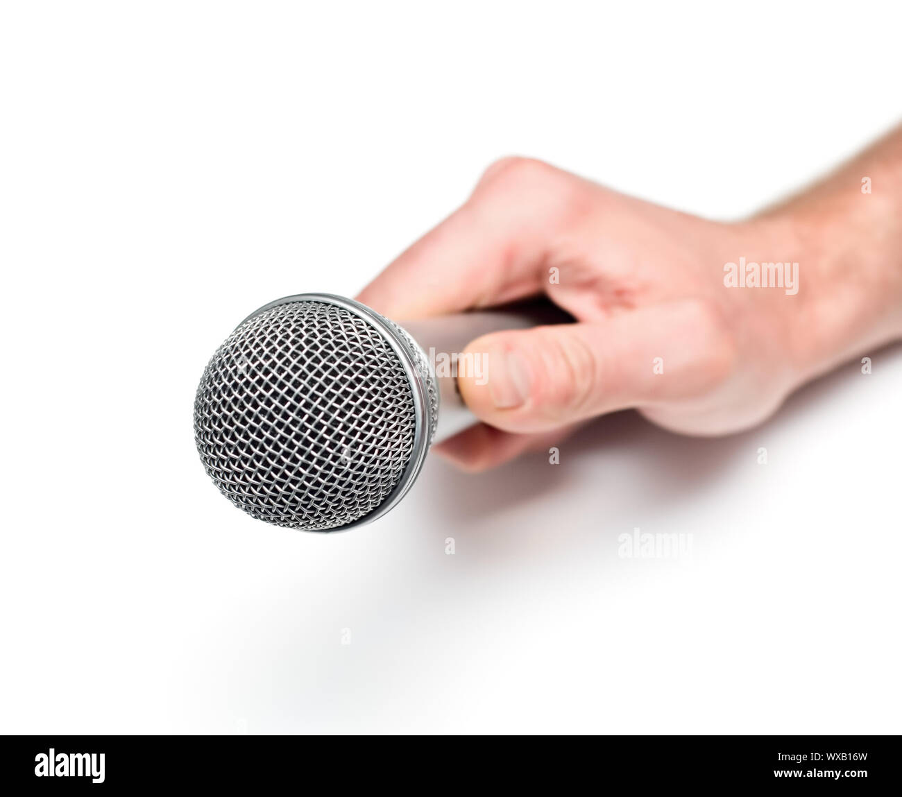 Hand holding microphone on white background Stock Photo - Alamy