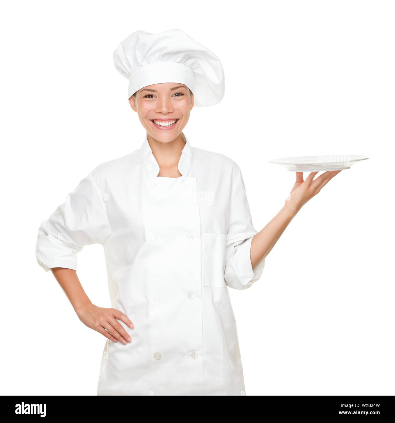 Chef showing empty plate. Happy smilng portrait of female in chef ...
