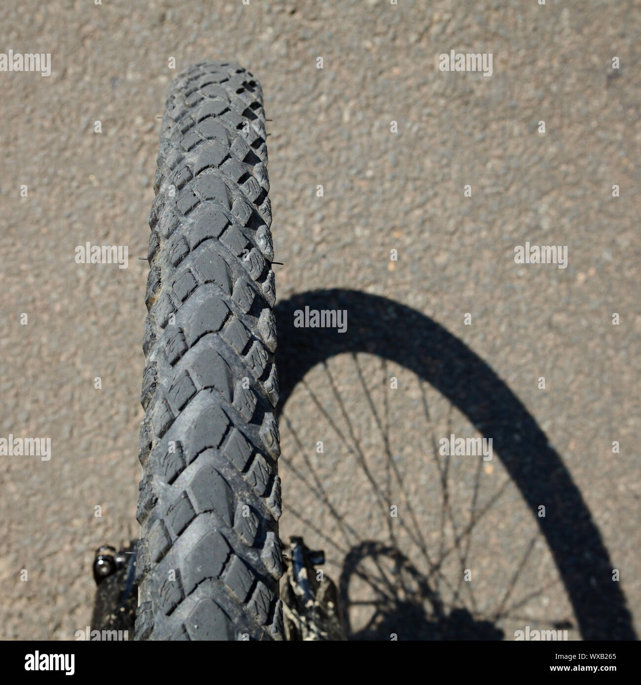 Old bike wheel shadow on road hi-res stock photography and images - Alamy