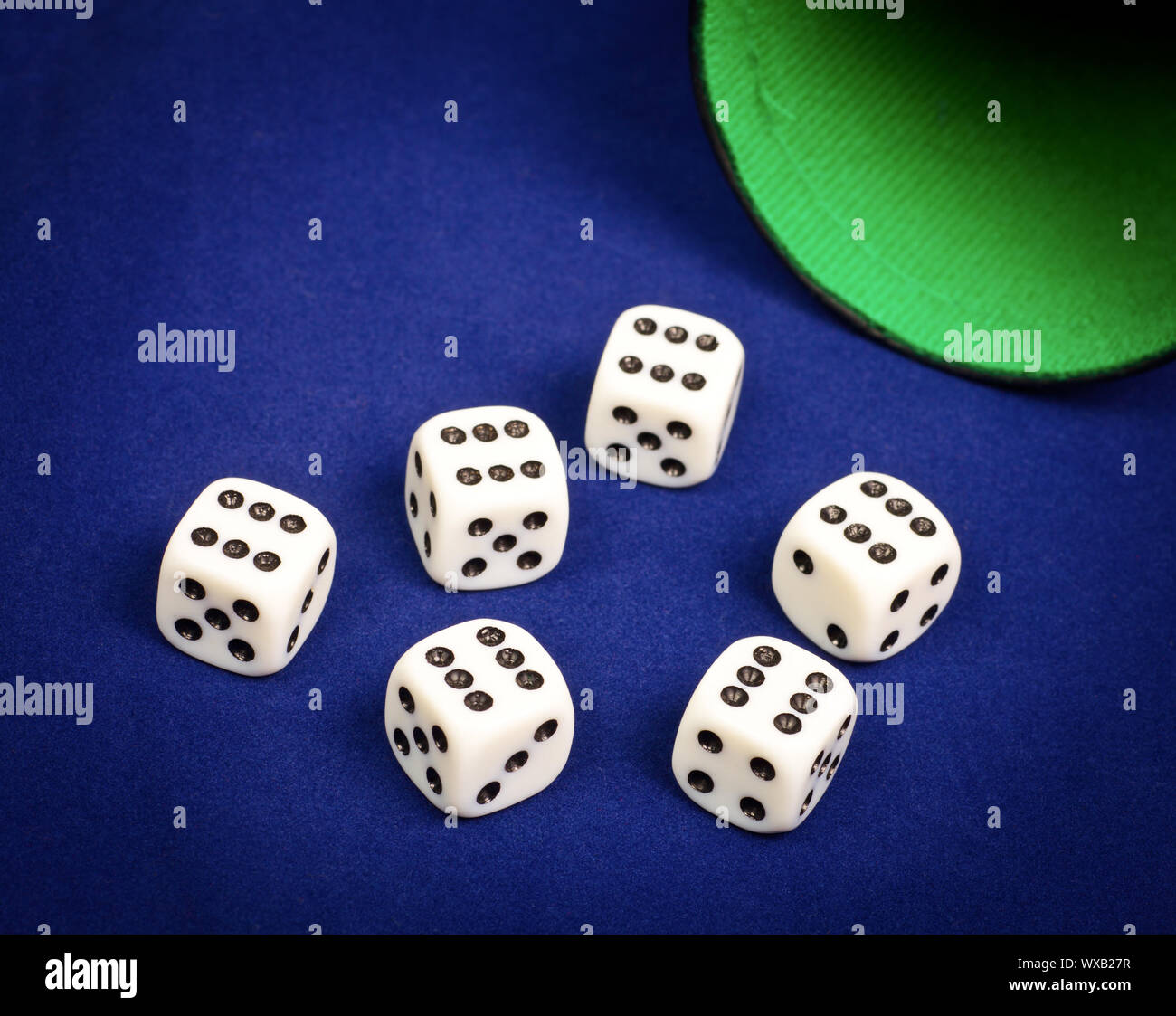 Six dice with number six facing up on blue board Stock Photo - Alamy
