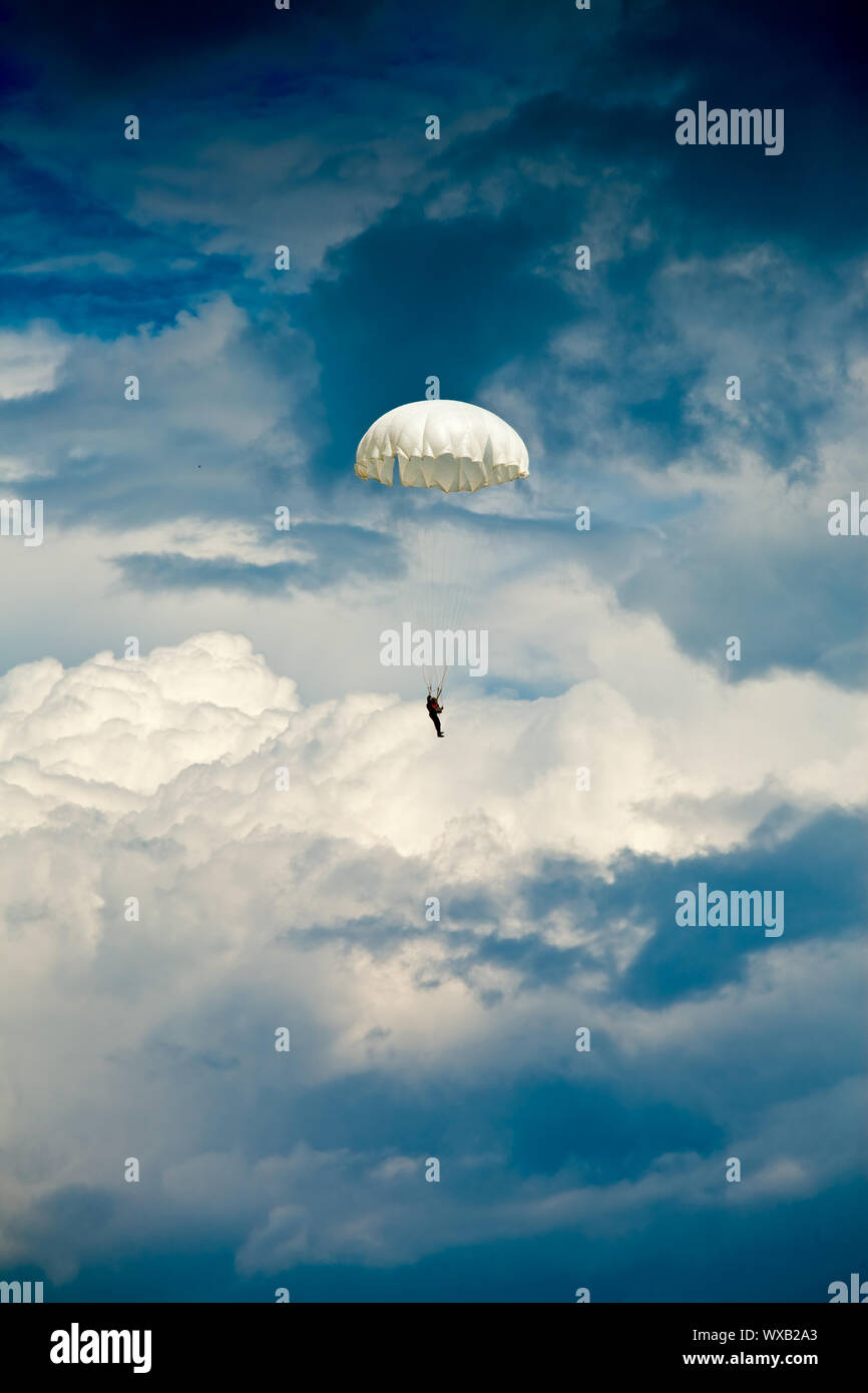 Parachute jumper against dramatic sky Stock Photo - Alamy