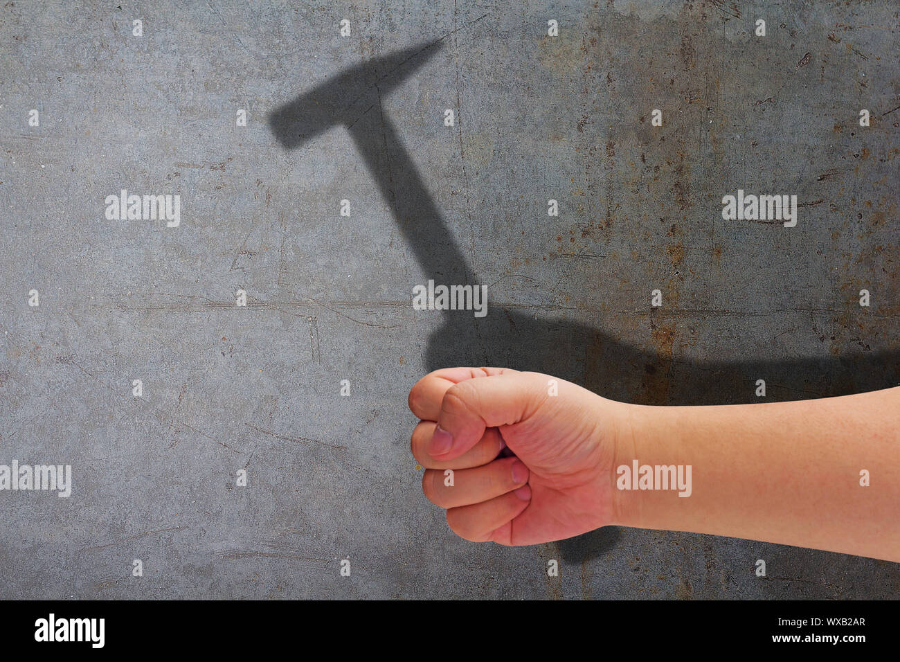 Strong and strength concept, hand and hammer shadow on concrete ...