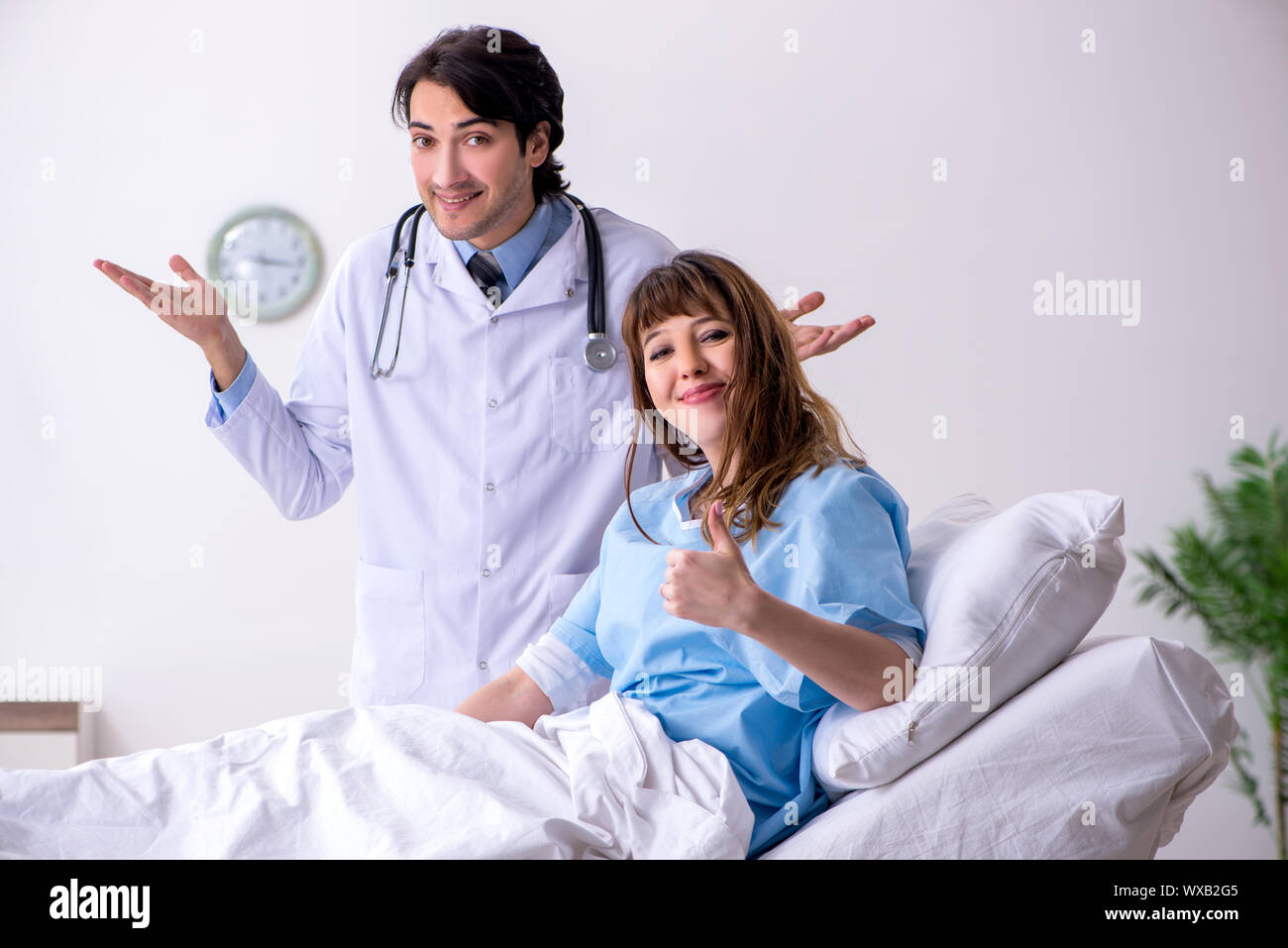 Male doctor visiting female patient in ward Stock Photo - Alamy