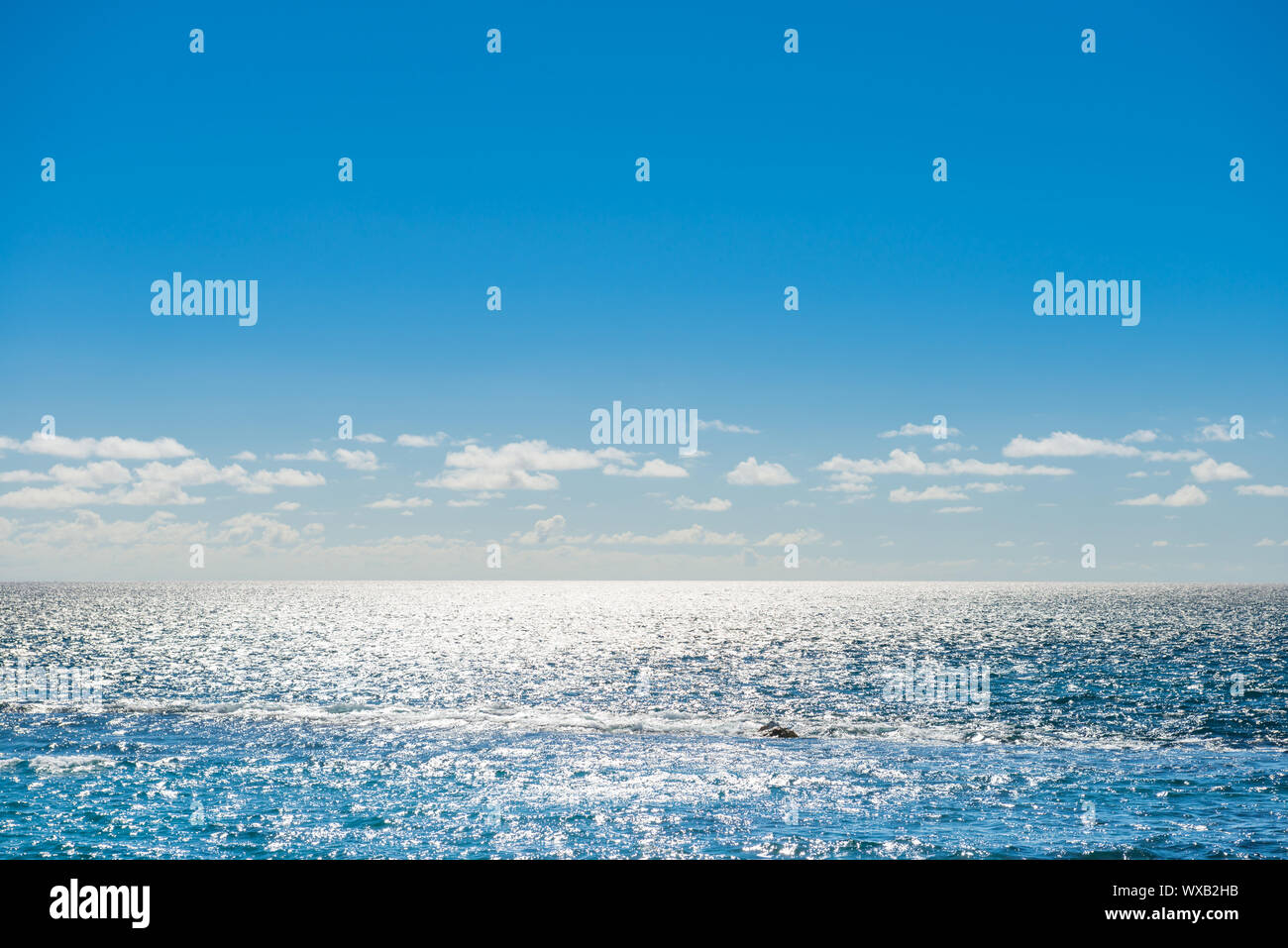 Seascape with sunlight reflection and calm waves Stock Photo - Alamy
