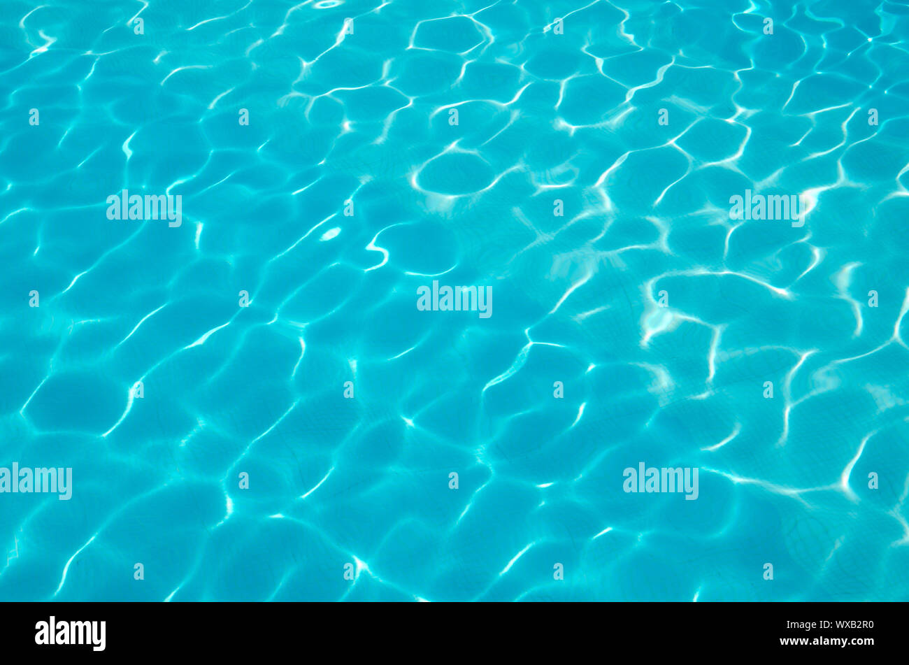 Blue pool water with sun reflections Stock Photo - Alamy
