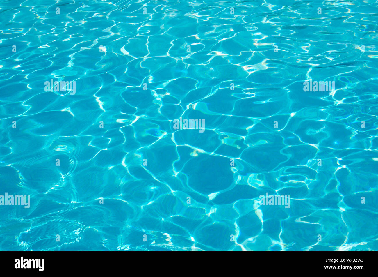 Blue pool water with sun reflections Stock Photo - Alamy