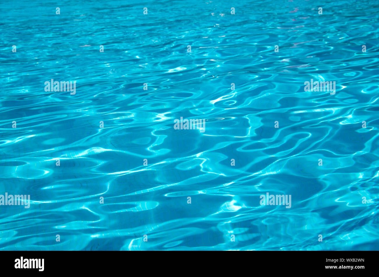 Blue pool water with sun reflections Stock Photo - Alamy