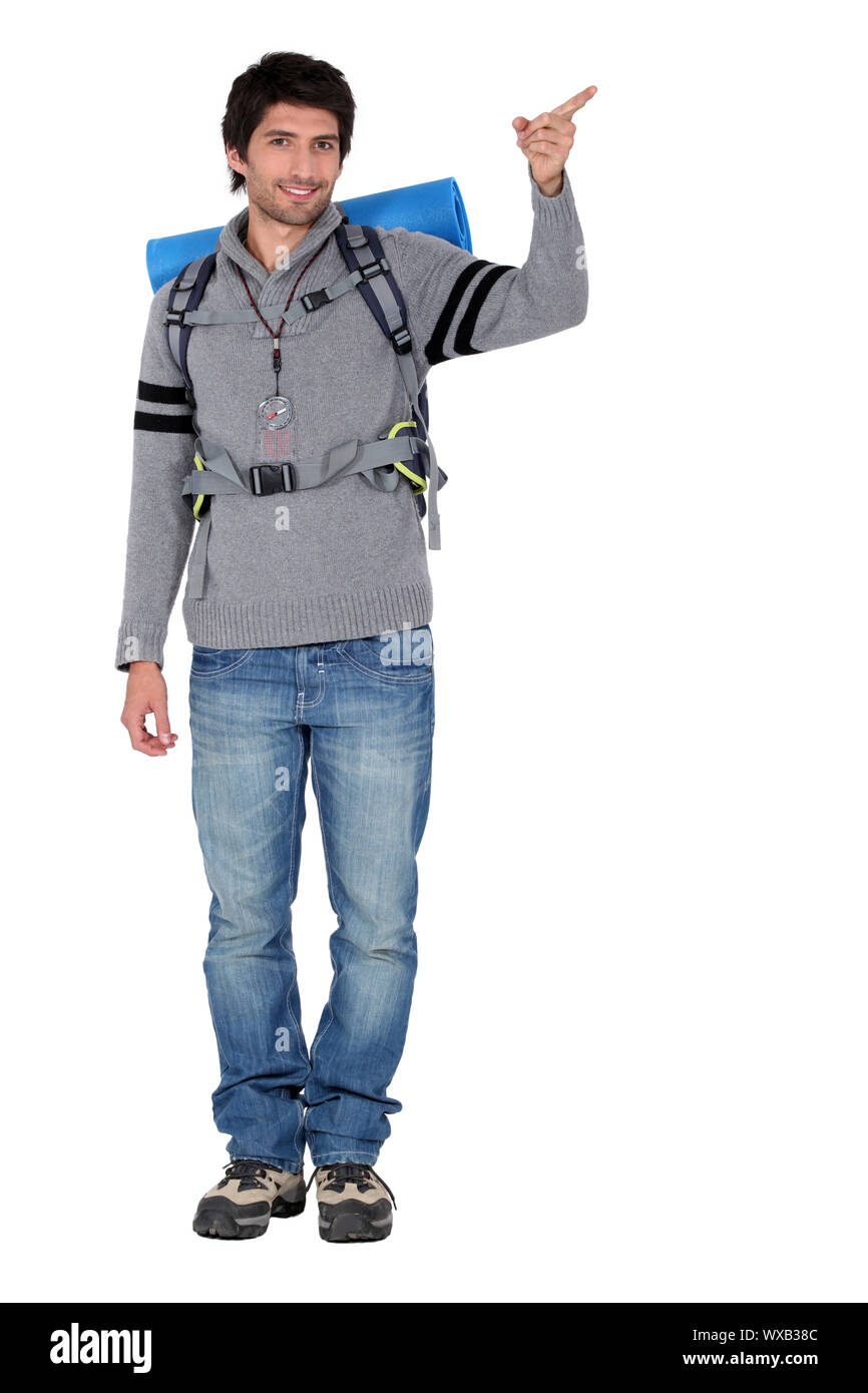 Backpacker pointing the way Stock Photo - Alamy