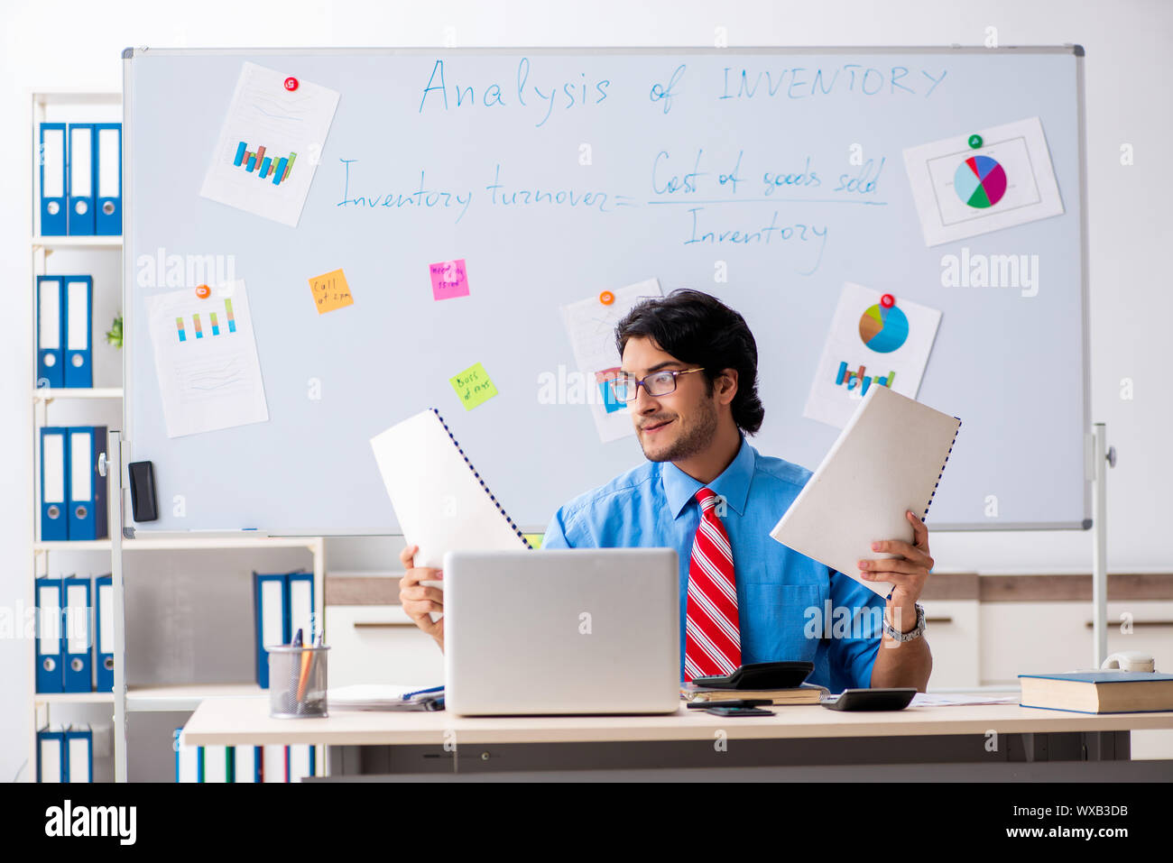 Young male financial manager working in the office Stock Photo - Alamy