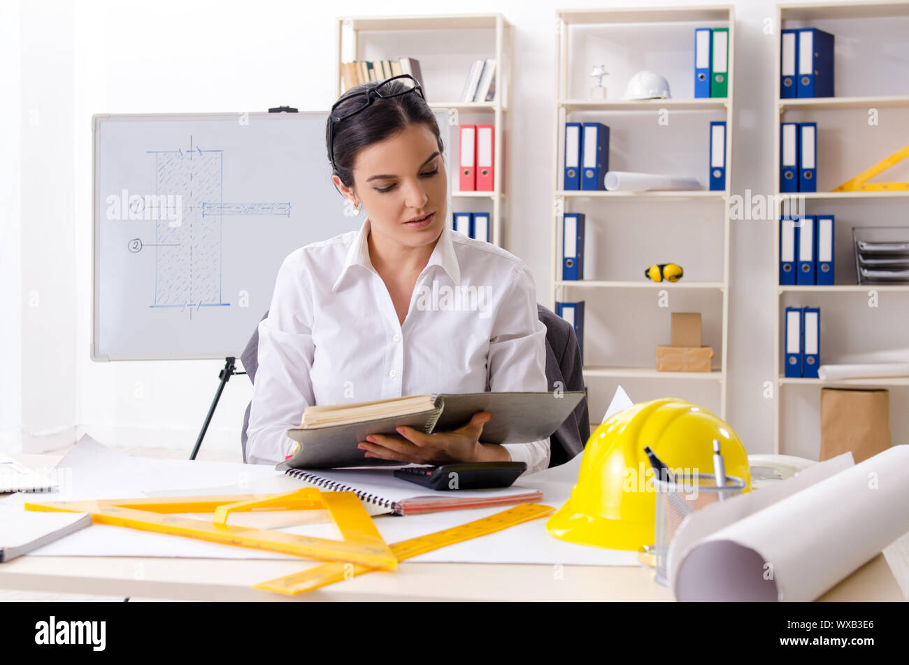 Female architect working in the office Stock Photo - Alamy