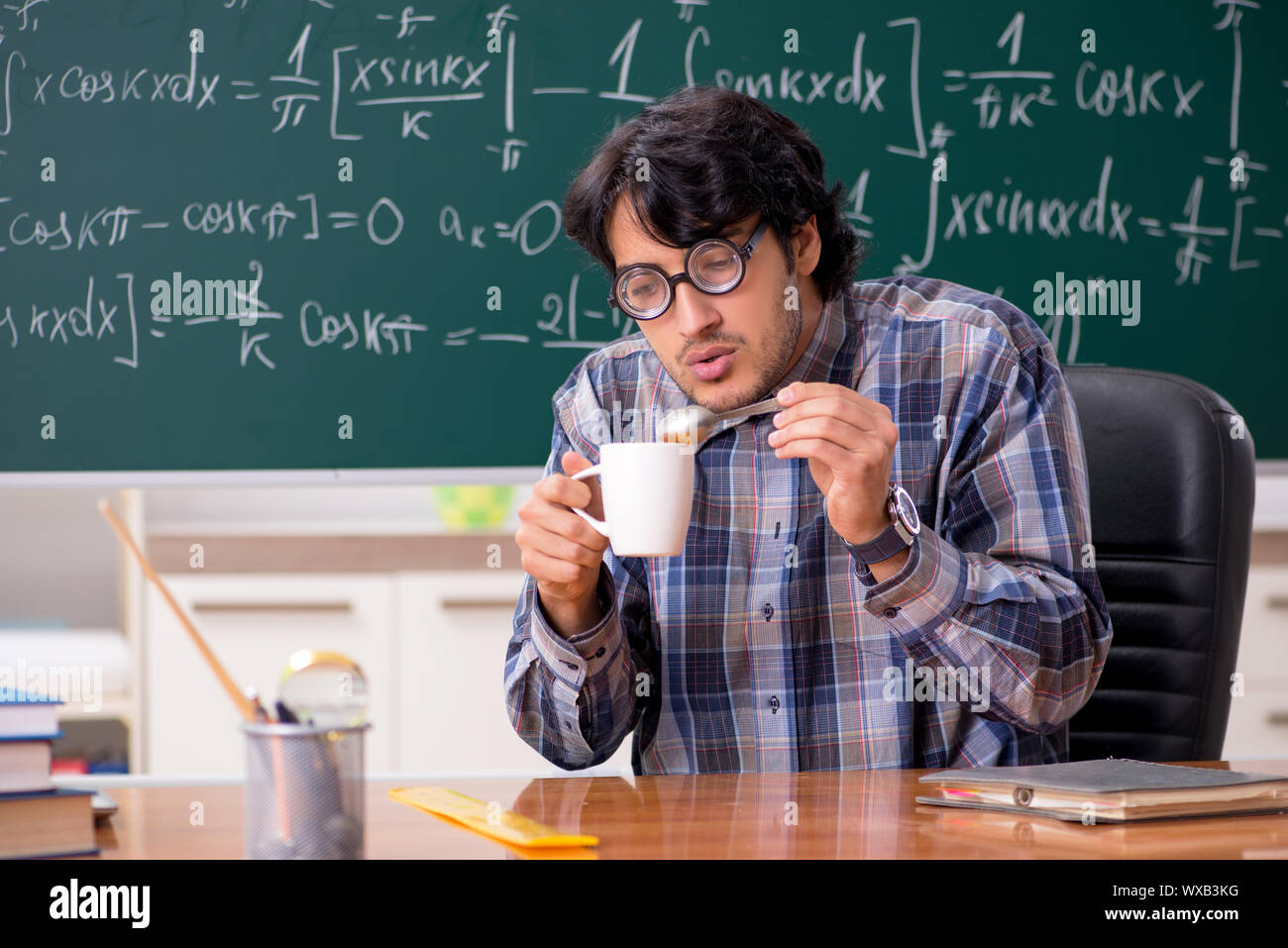 Funny male math teacher in the classroom Stock Photo - Alamy