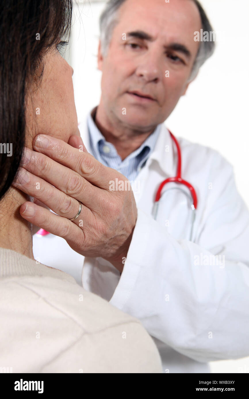 Doctor examining patient Stock Photo - Alamy