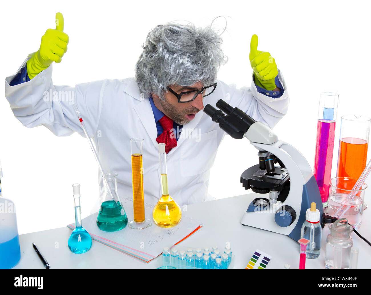 Crazy mad nerd scientist at laboratory microscope ok hand sign gesture ...