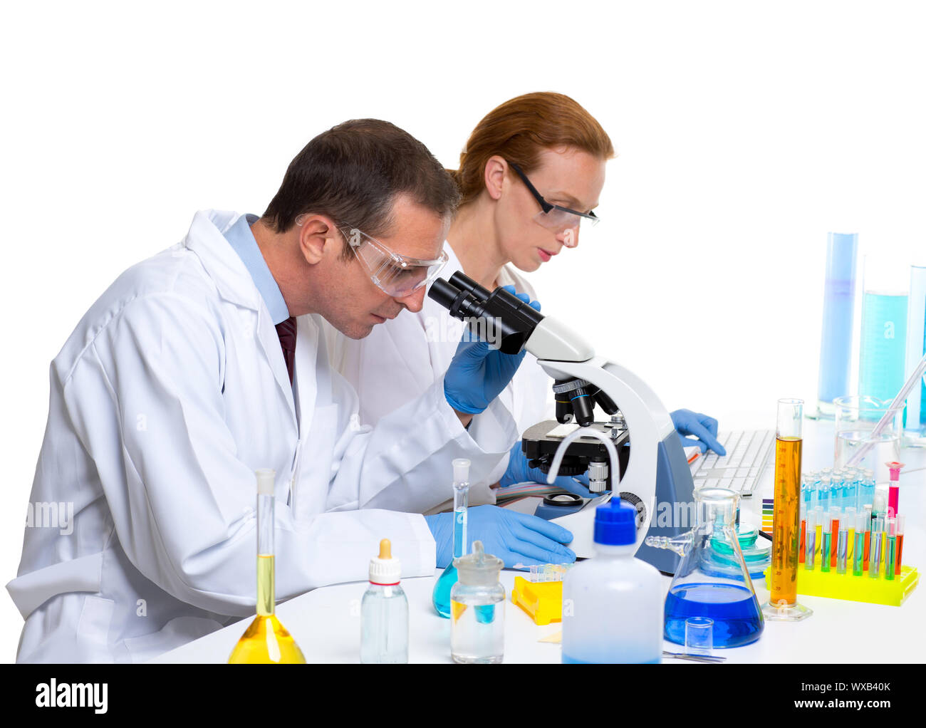 laboratory with two scientist working with test tubes flask and ...