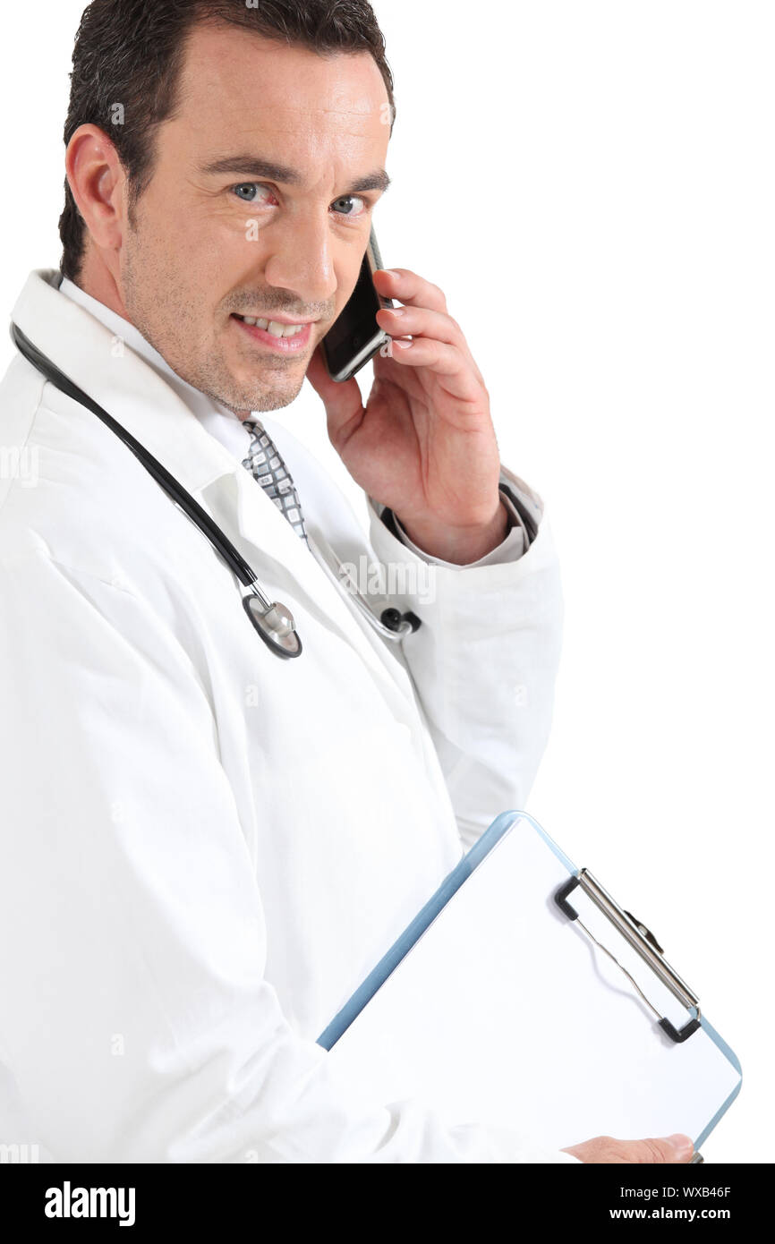 Doctor on phone smiling Stock Photo - Alamy