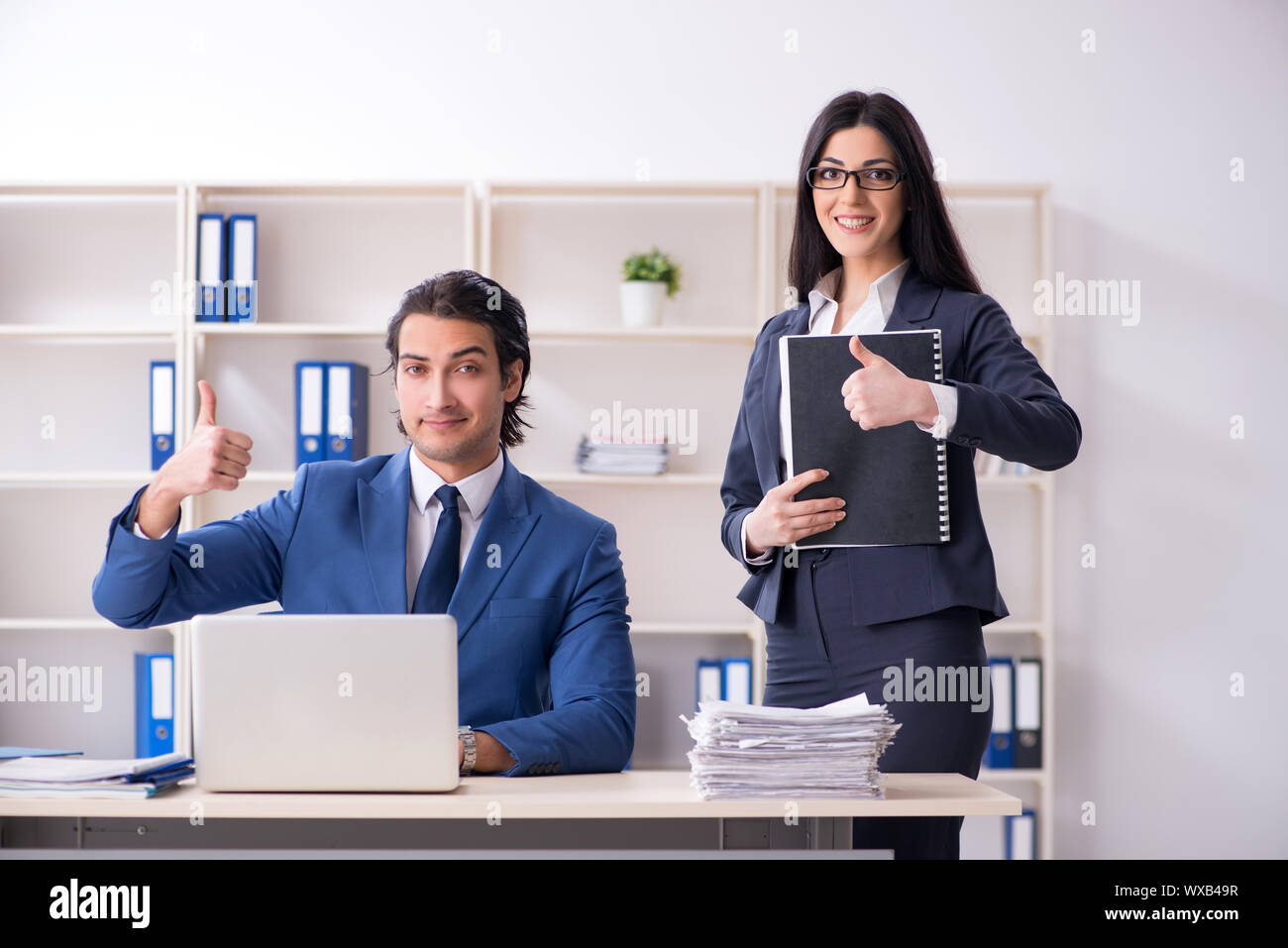 Two employees working in the office Stock Photo - Alamy