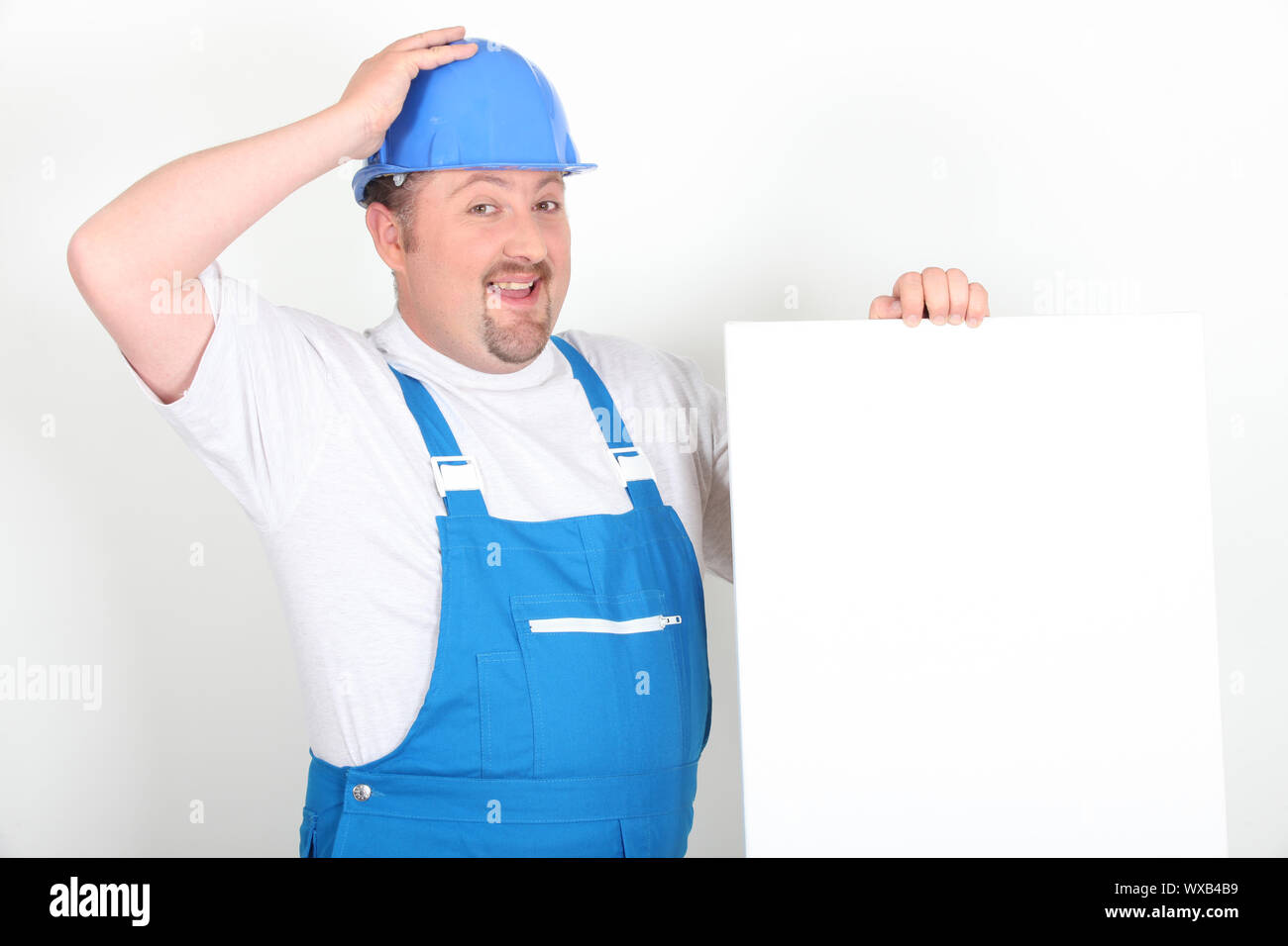 Worker holding up a blank sign Stock Photo - Alamy