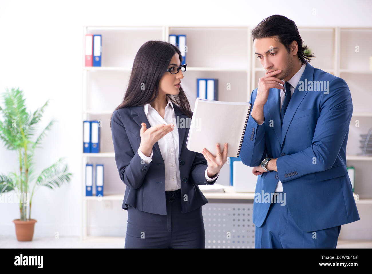 Two employees working in the office Stock Photo - Alamy