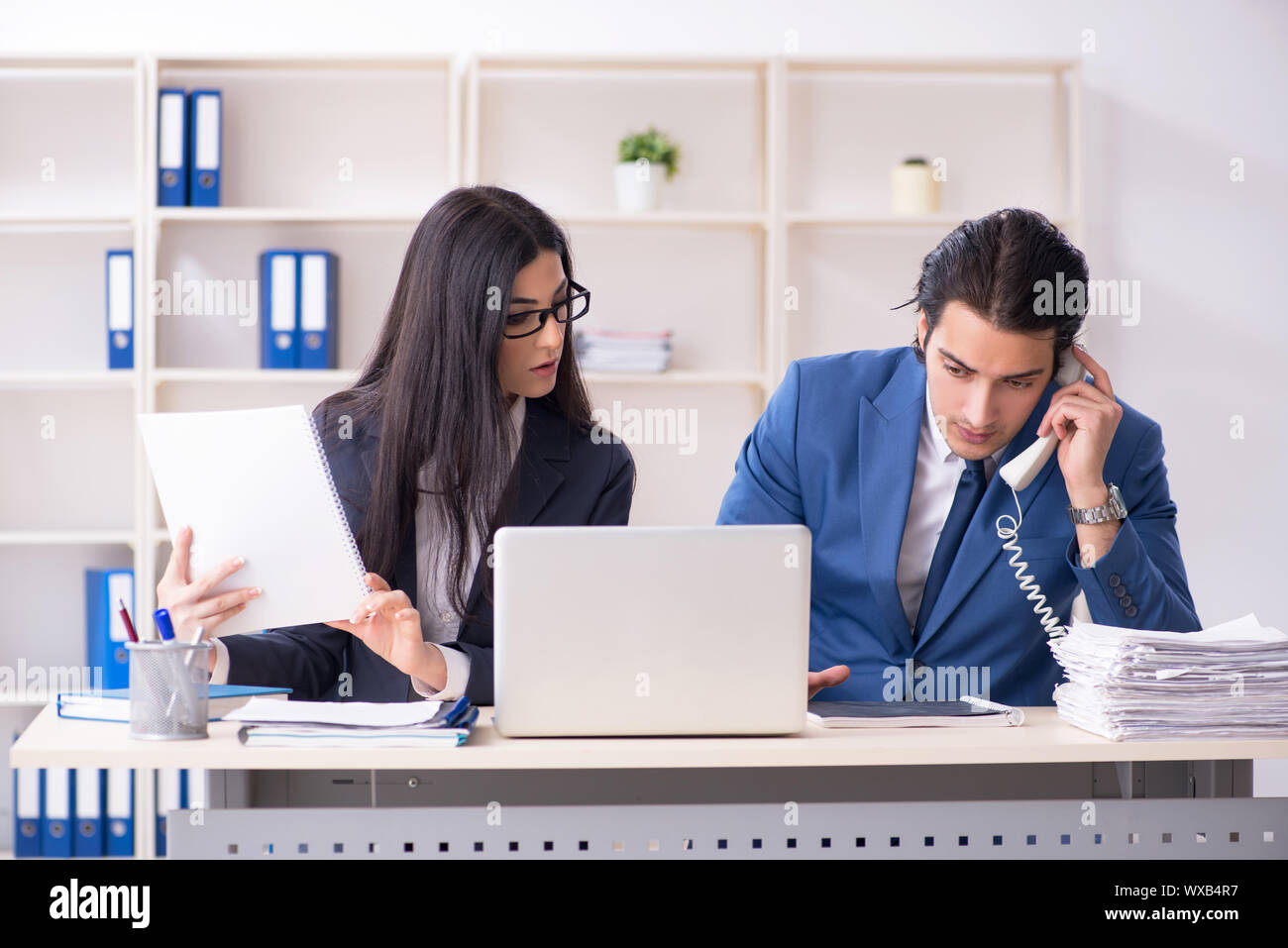Two employees working in the office Stock Photo - Alamy