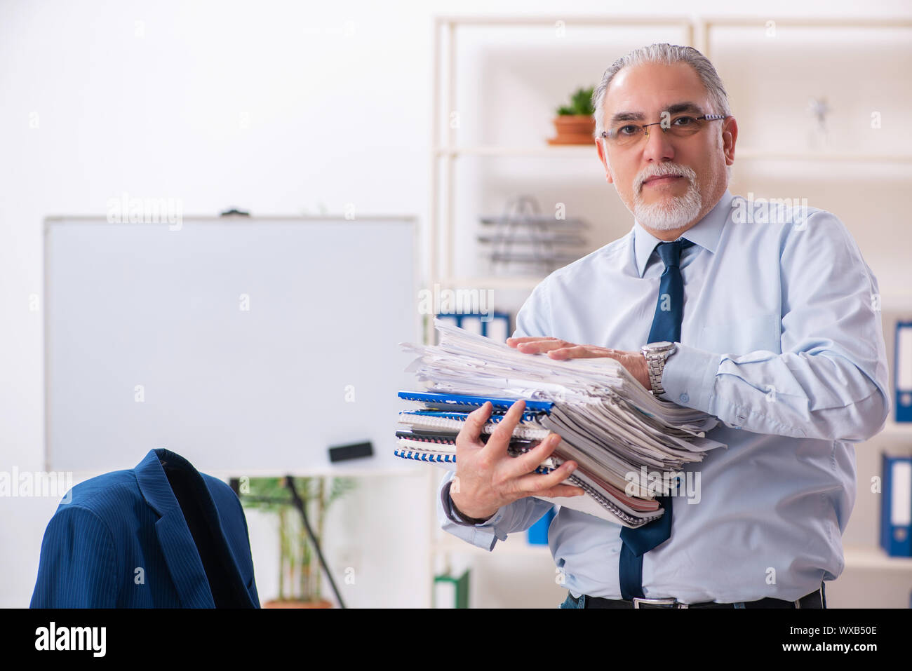Aged male employee working in the office Stock Photo - Alamy
