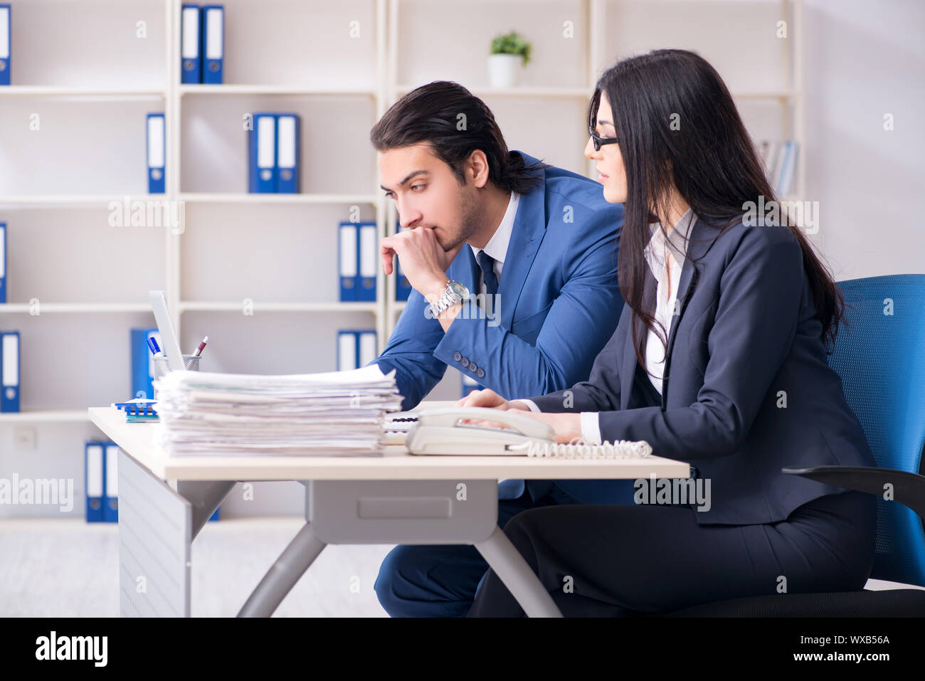 Two employees working in the office Stock Photo - Alamy