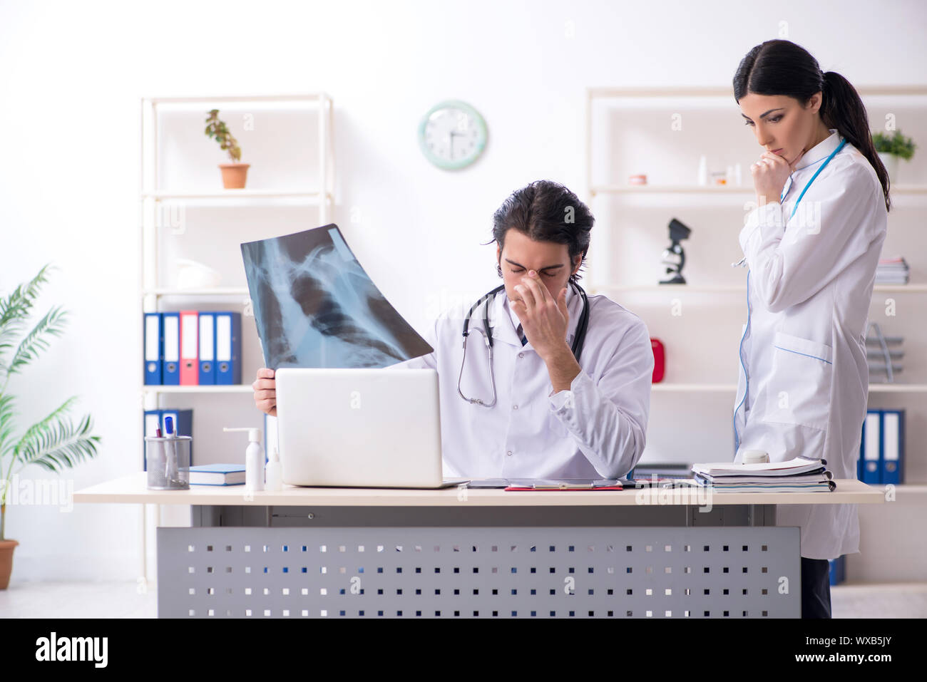Two young doctors working in the clinic Stock Photo - Alamy