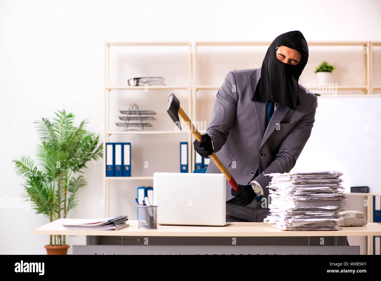 Male gangster stealing information from the office Stock Photo - Alamy