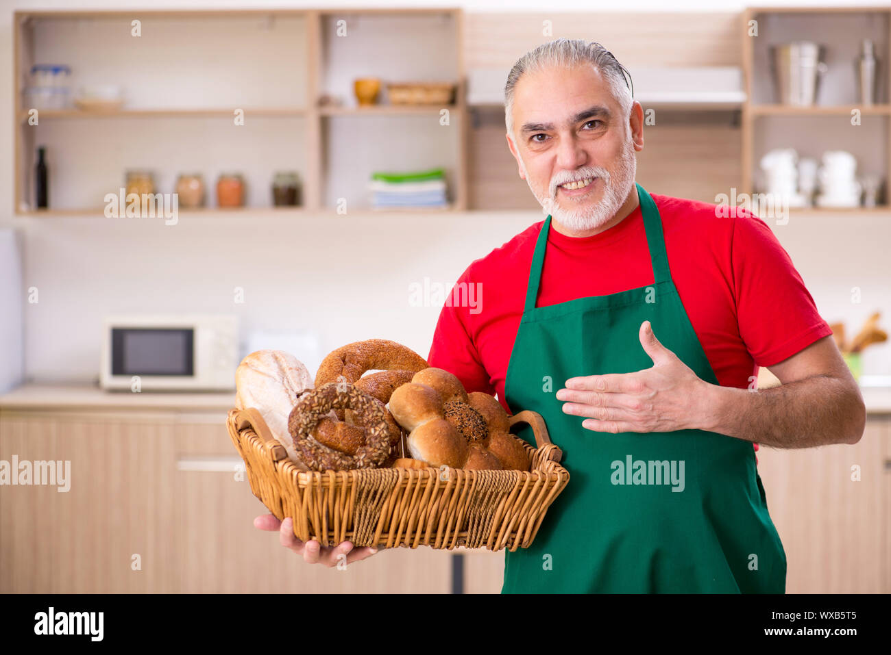 Old male baker working in the kitchen Stock Photo - Alamy
