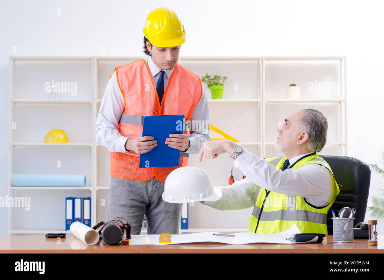 Two engineers colleagues working under project Stock Photo - Alamy