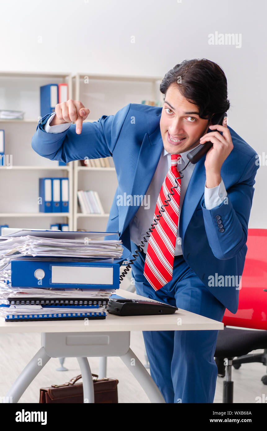 Young happy male employee in the office Stock Photo - Alamy