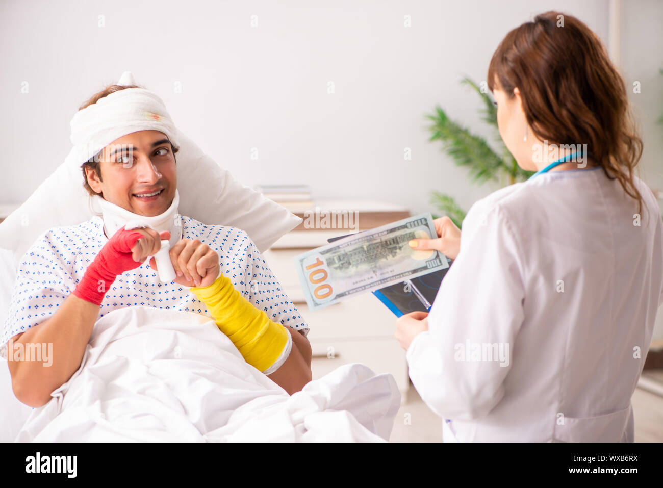 Young doctor examining injured patient Stock Photo - Alamy
