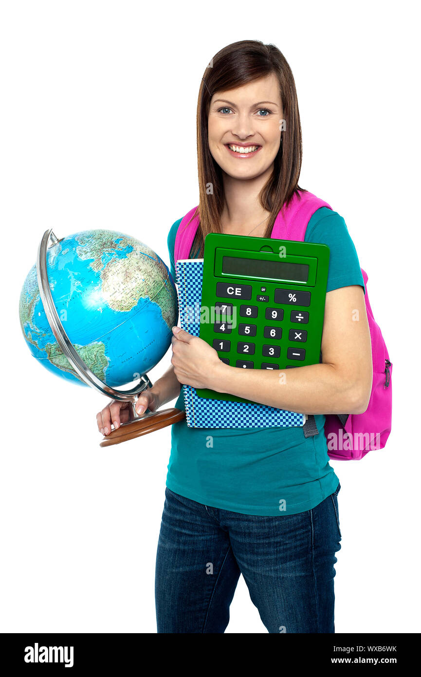 Smiling female student holding a calculator and globe, carrying pink ...