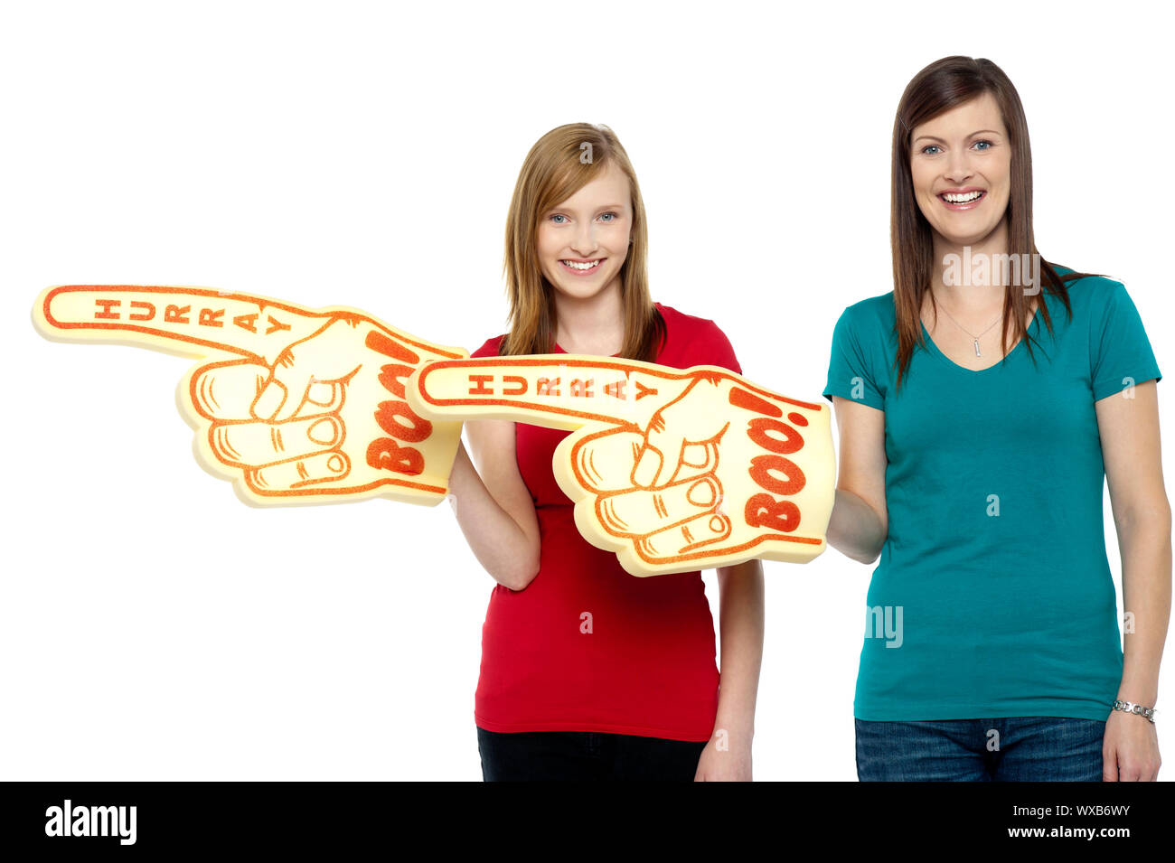 Cheerful fans pointing the big foam hand sideways. Half length portrait ...
