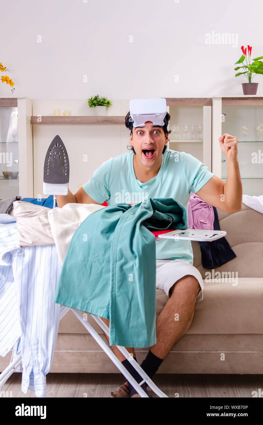 Young man husband ironing at home Stock Photo - Alamy