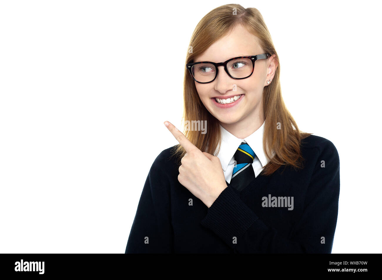 Bespectacled smiling student pointing away. Cheeky expression Stock ...