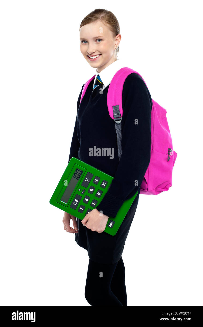 Side pose of an attractive school girl posing with backpack and ...