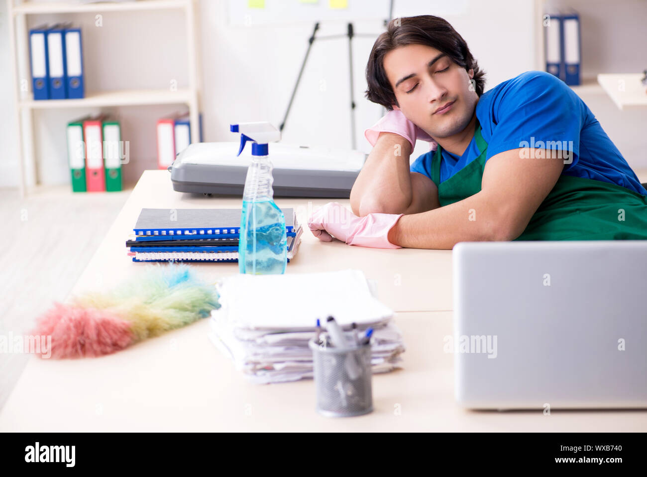 Male handsome professional cleaner working in the office Stock Photo ...