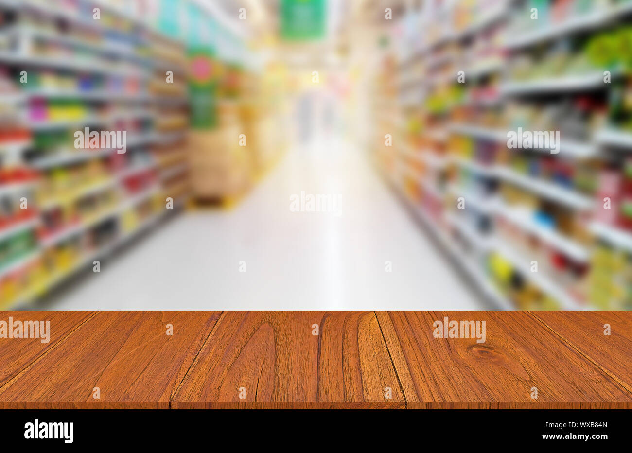 Wood table on food product shelf in supermarket, montage or display ...