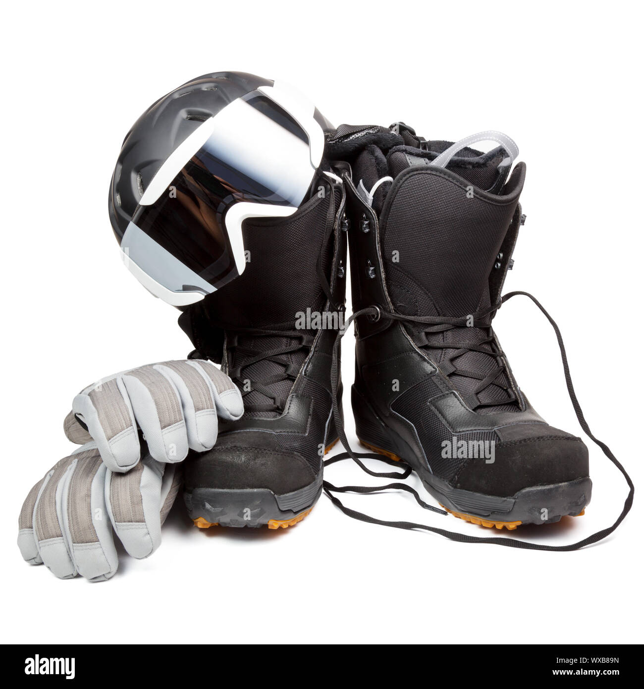 Snowboard boots with helmet gloves and goggles on white background ...