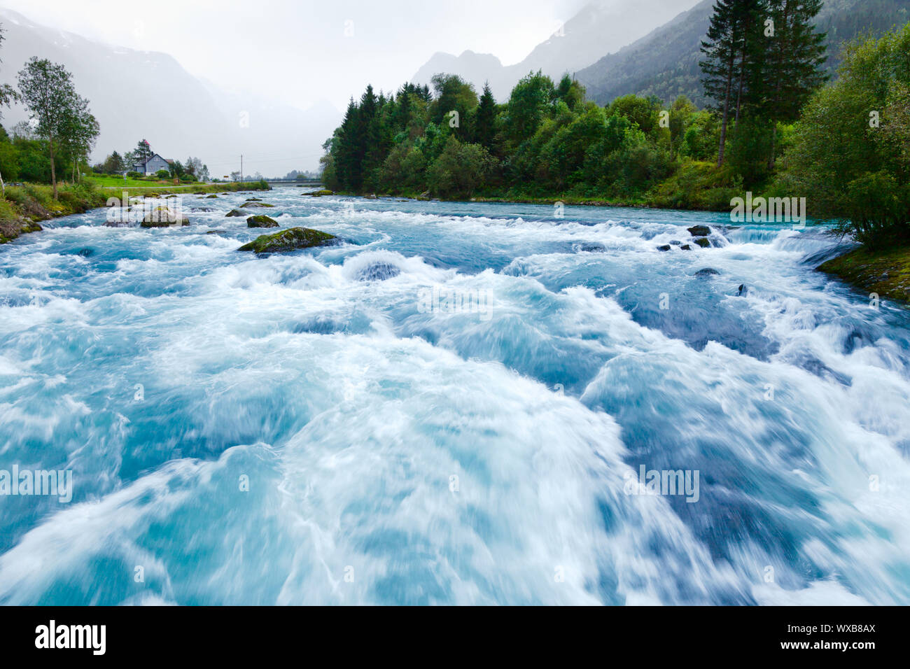 Milky blue glacial water of Briksdal River in Norway Stock Photo - Alamy