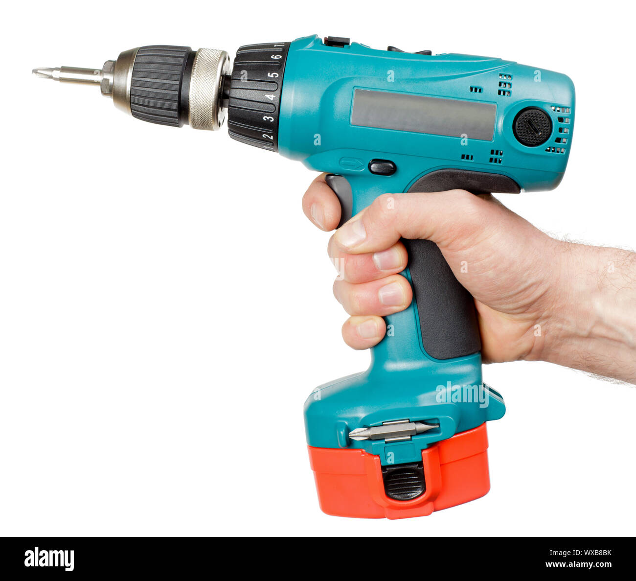 Hand holding battery-powered electric drill with fastener on white ...